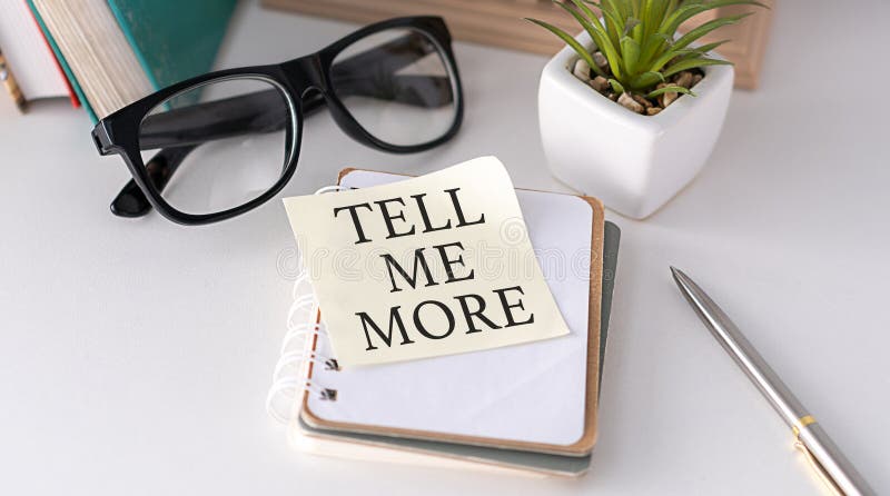 TELL ME MORE Text on Notebook with Keyboard , Pen and Alarm Clock on ...