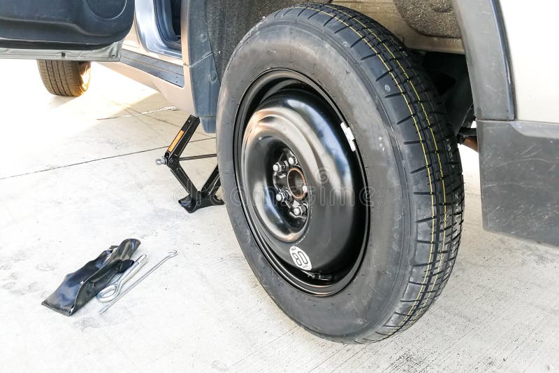 Temporary Emergency Tire Replaced Onto Car Wheel after Flat Tire Stock ...