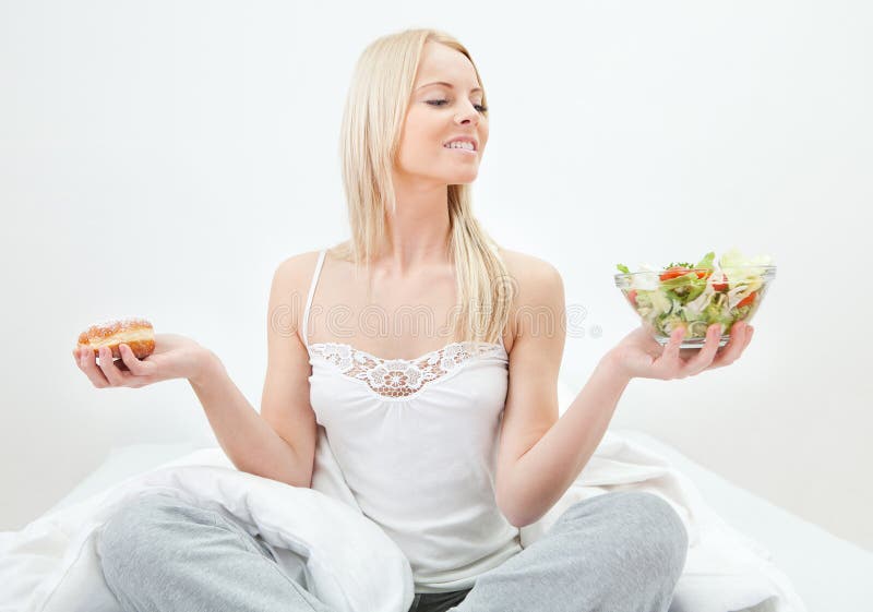 Tempted Young Woman Making a Food Choice Stock Image - Image of junk ...