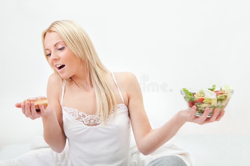 Tempted Young Woman Making a Food Choice Stock Image - Image of junk ...
