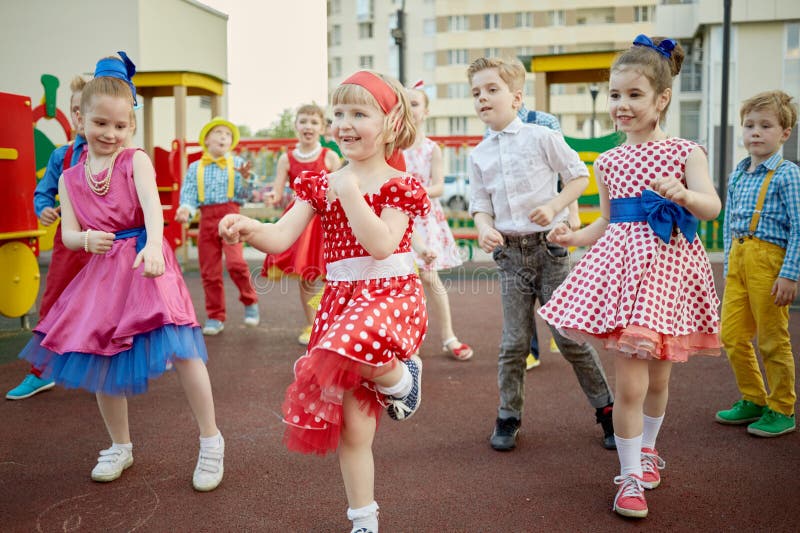 Ten Children Dance at Playground in Stock Photo - Image of costume ...