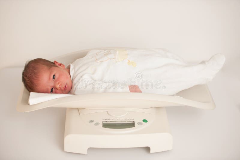 Ten Days Old New Born Child on a Scale Measuring Weight Stock Photo ...