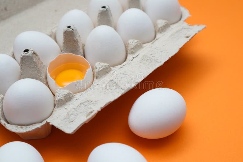 Ten White Eggs in a Carton Package. Cardboard Egg Box on Orange ...
