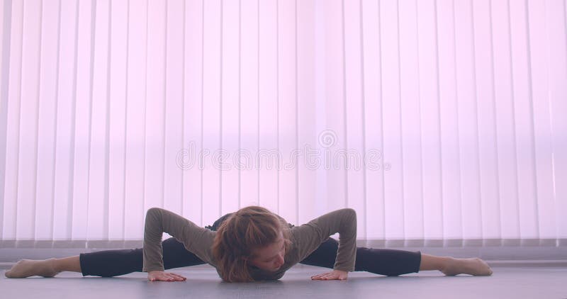 Tender Caucasian Professional Ballerina Lying in Leg-split Warming Up ...