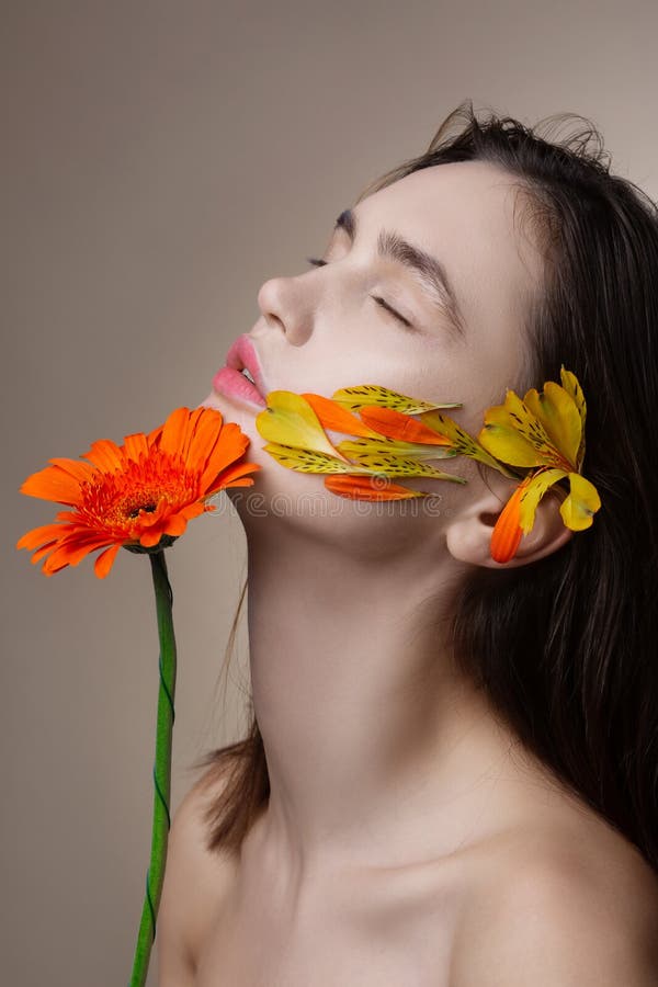 Model with Petals on Face and Flower in Hands Closing Eyes Stock Photo ...