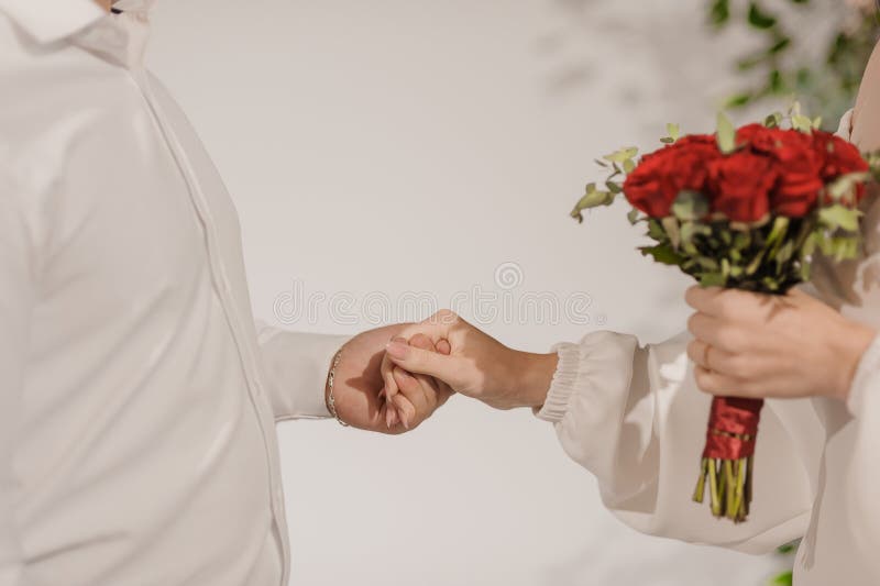 A Tender Moment Capturing a Wedding Ceremony with Two People Holding ...