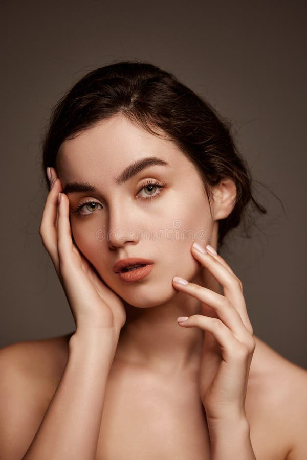 Tenderness Portrait Of Young Beautiful Girl With Brown Hair And Nude Makeup Style Posing Over