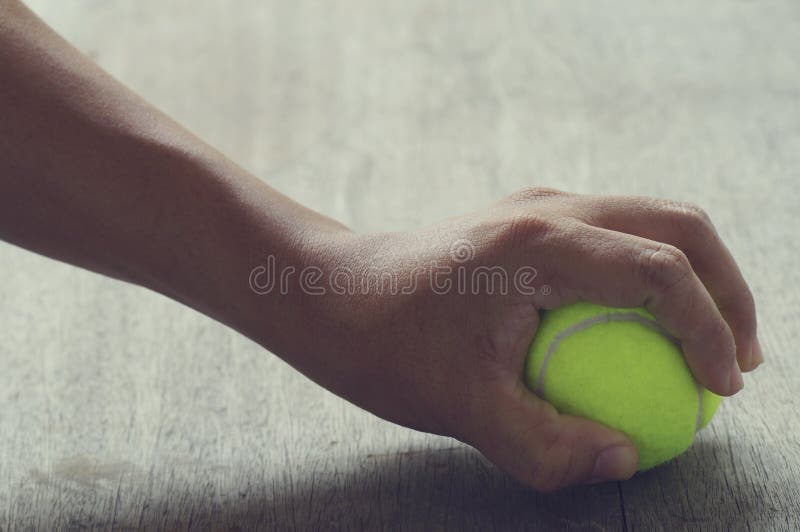 Tennis ball in hand stock photo. Image of beauty, health - 83590658