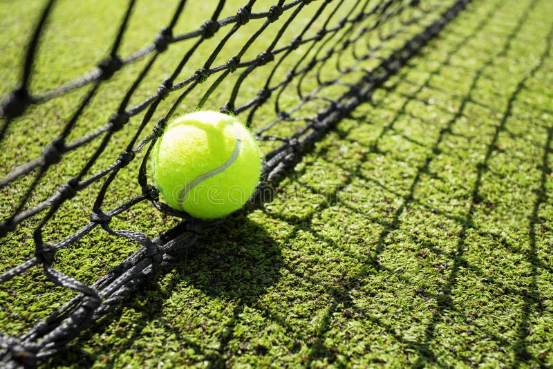 Tennis ball in the net stock photo. Image of competition - 64078358