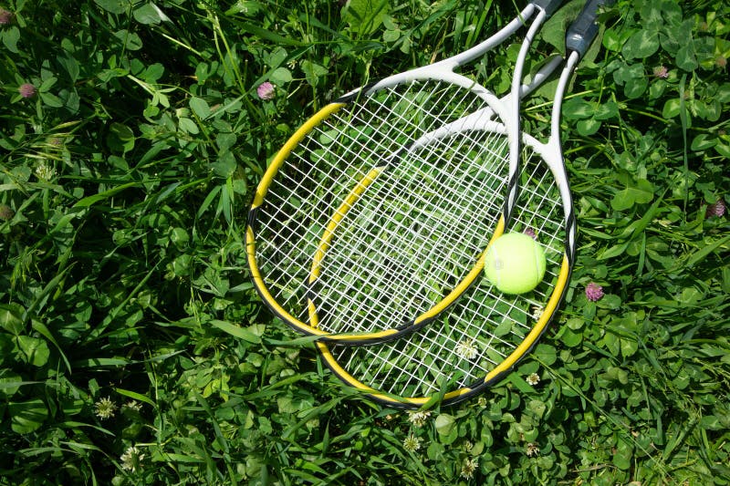 Tennis Ball and Racket on the Green Grass Background Stock Photo ...