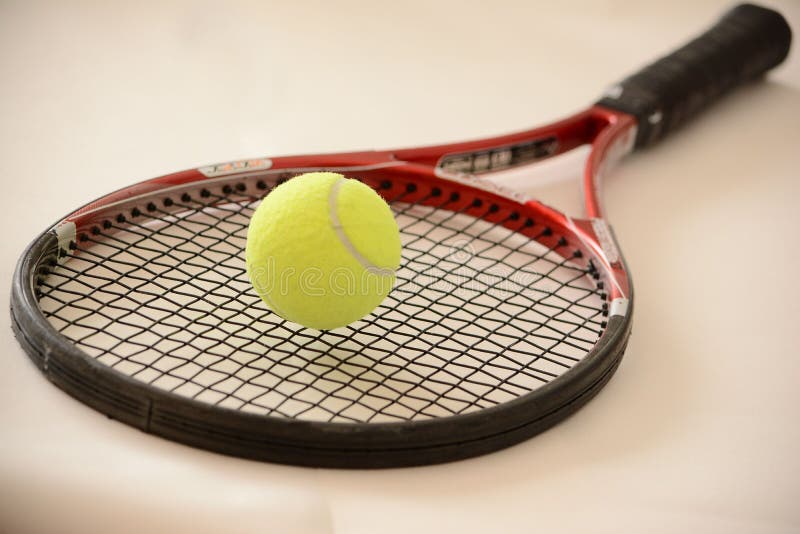 Tennis Ball on a Racquet stock image. Image of isolated - 57046027
