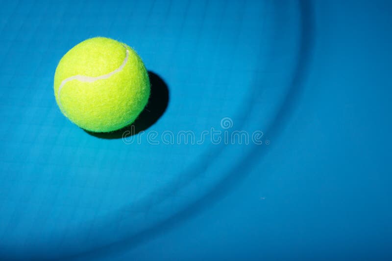 Tennis Ball in the Shadow of a Racket on a Blue Background Stock Photo ...
