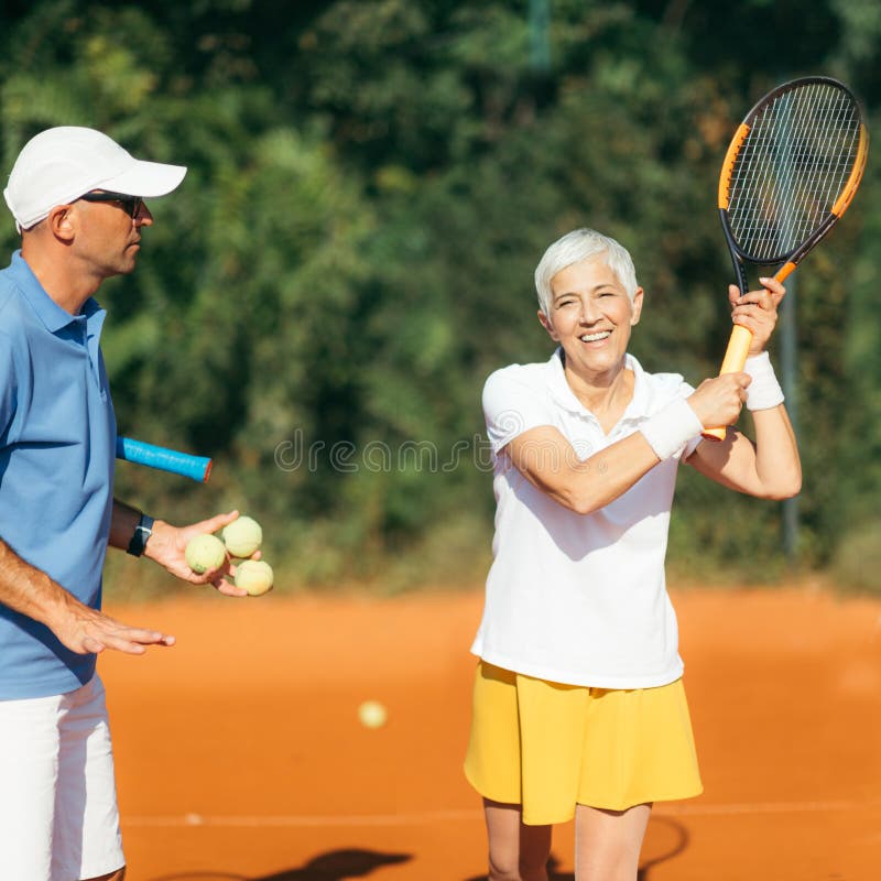 Tennis Instructor with Senior Woman, Tennis Training Lesson Stock Photo ...