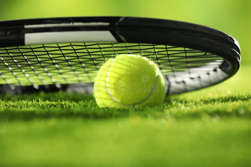 Tennis Racket and Ball on Green Grass, Closeup Stock Image - Image of ...