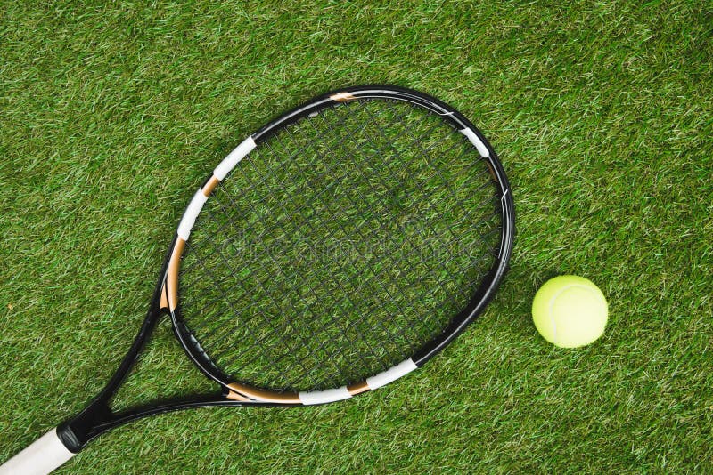 Tennis Racket and Ball Lying on Green Lawn Stock Photo - Image of hobby ...