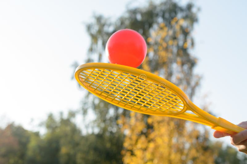 A Tennis Racket in His Hand Catches the Ball in Motion. Stock Photo ...