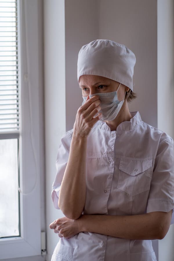 A Tense Female Doctor Wearing a Face Mask. Stock Photo - Image of ...
