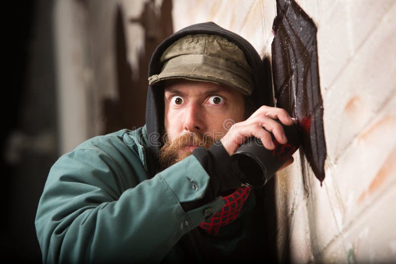 Tense Man Tagging a Wall stock photo. Image of building - 32107206