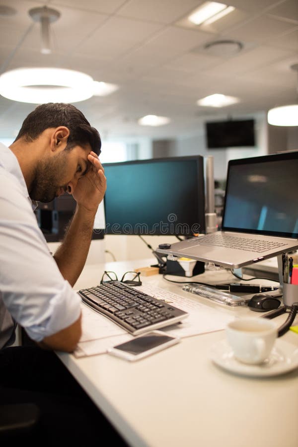 Tensed Businessman Talking on Land Line in Office Stock Photo - Image ...
