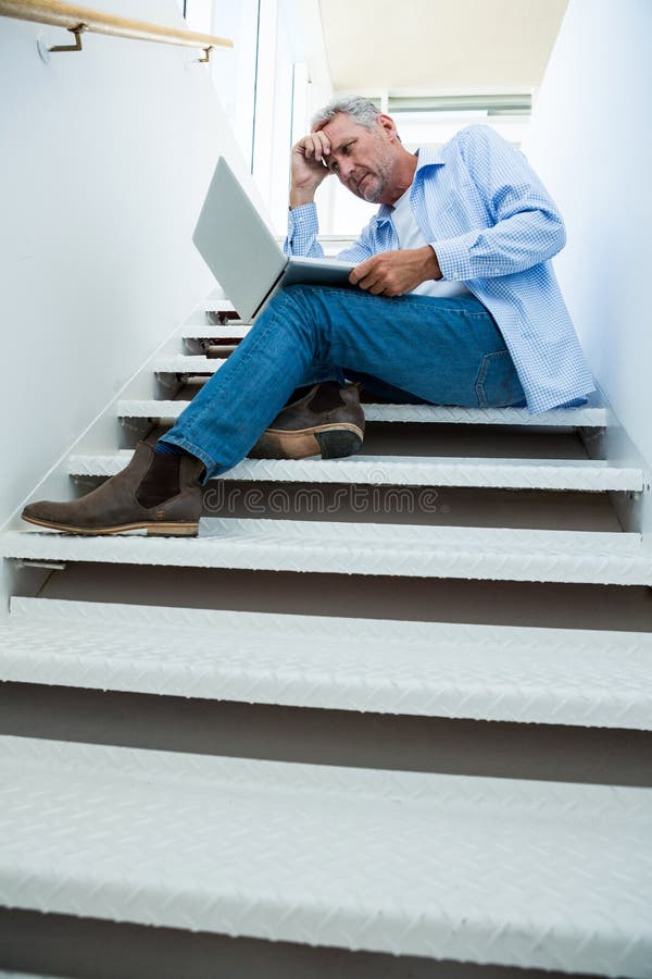Tensed Man Using Laptop on Steps Stock Photo - Image of laptop ...