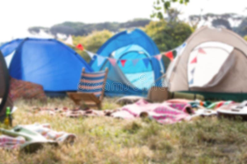 Tents by Bunting and Chair on Grassy Field Stock Image - Image of sheet ...