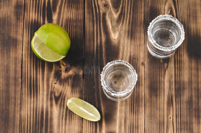 Tequila Shots with Lime Slices and Salt on Wooden Table/Tequila Shots ...