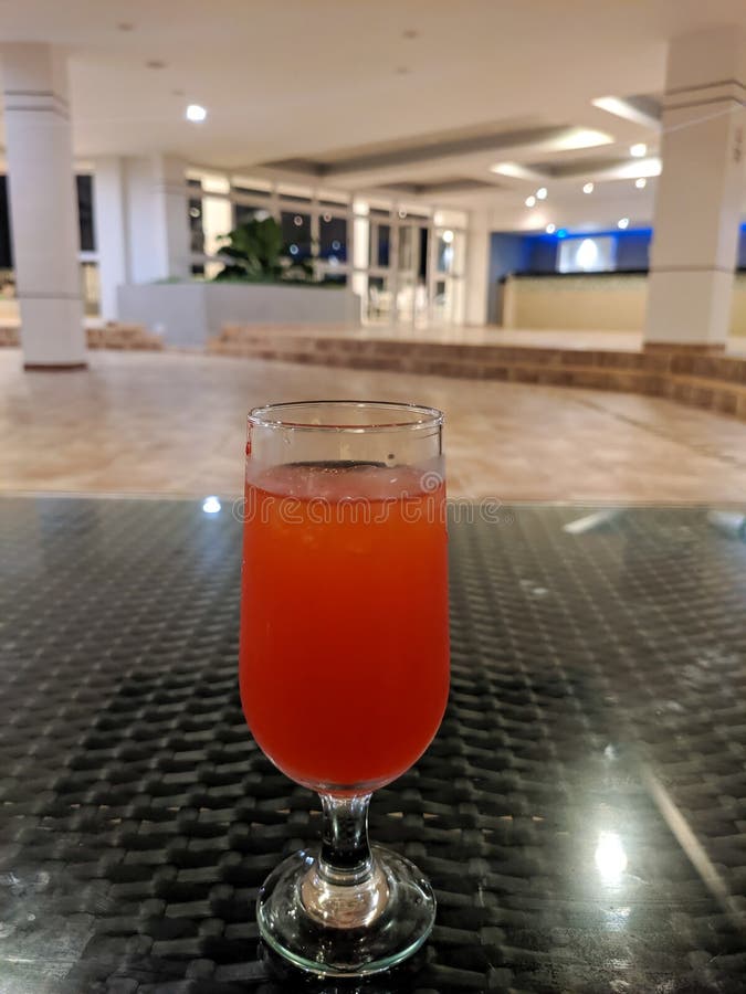 Tequila Sunrise Cocktail Stands on the Table Against the Backdrop of ...