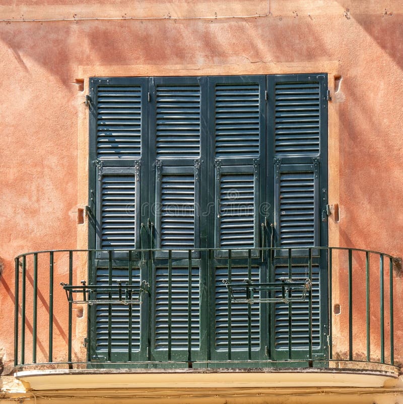 Terrace Featuring Dark Green Window Shutters on an Orange-colored ...