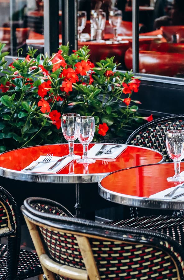 Terrace of a Parisian Restaurant with Red Tables and Red Flowers Stock ...