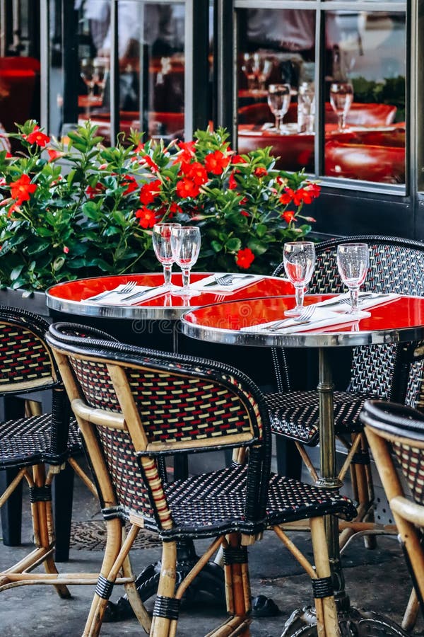 Terrace of a Parisian Restaurant with Red Tables and Red Flowers Stock ...