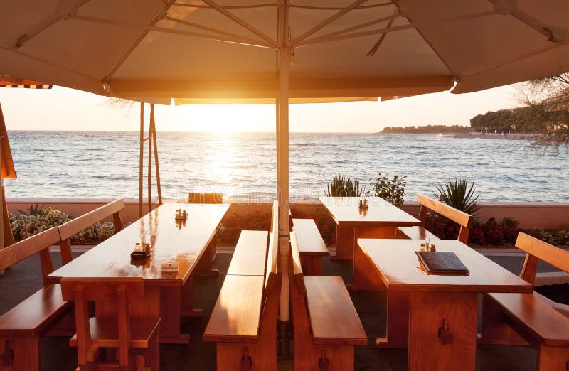 Terrace Restaurant Tables Under Parasol at Sunset Stock Photo - Image ...