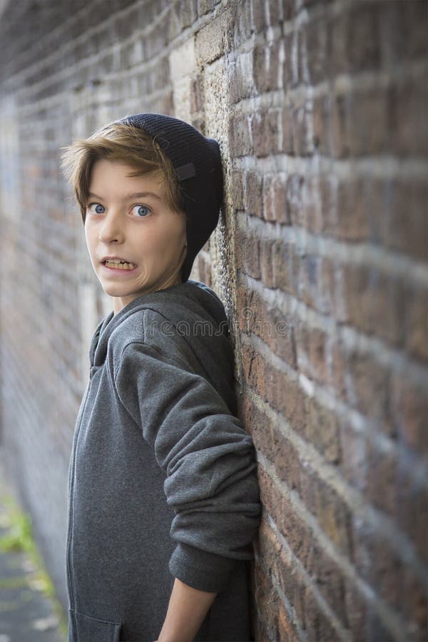 Terrified Teenager Boy Leaning on a Wall Stock Photo - Image of teen ...