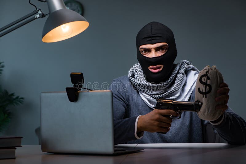 The Terrorist Burglar with Gun Working at Computer Stock Photo - Image ...