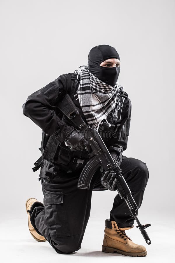 Armed Terrorist In Black Mask And Black Uniform Aiming With A Gun ...