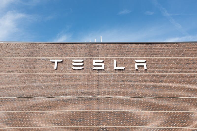 Tesla on brick wall editorial stock photo. Image of business - 287210138