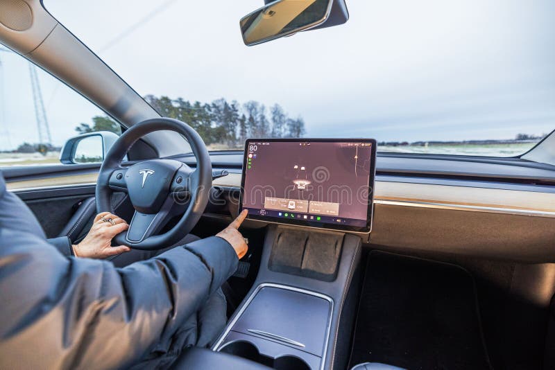 Tesla Model Y Driver Interacting with Touchscreen Display, Showcasing ...