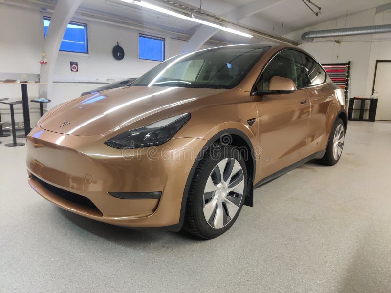 Tesla Modely Wrap Bronze Car Editorial Photo - Image of wrap, bronze ...