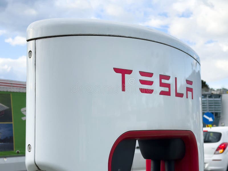 Tesla Supercharger Station Against Cloudy Sky with Red Logo Editorial ...