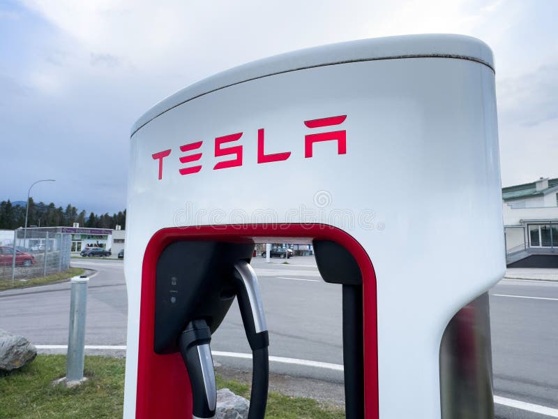 Tesla Supercharger Station with Dual Charging Cables Outdoors on Cloudy ...