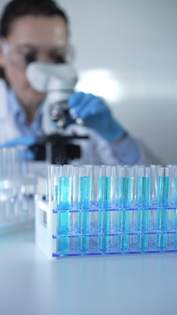 Test Tubes with a Blue Liquid, Close-up View. Scientist Using ...