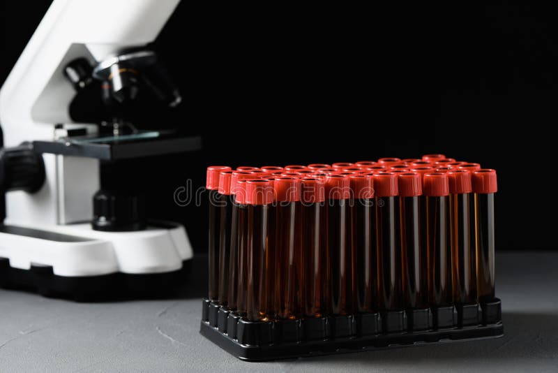Test Tubes with Brown Liquid in Stand on Grey Table Against Black ...