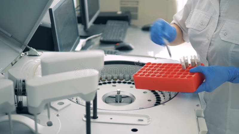 Test Tubes are Getting Inserted into a Biochemical Analyzer by a Lab ...
