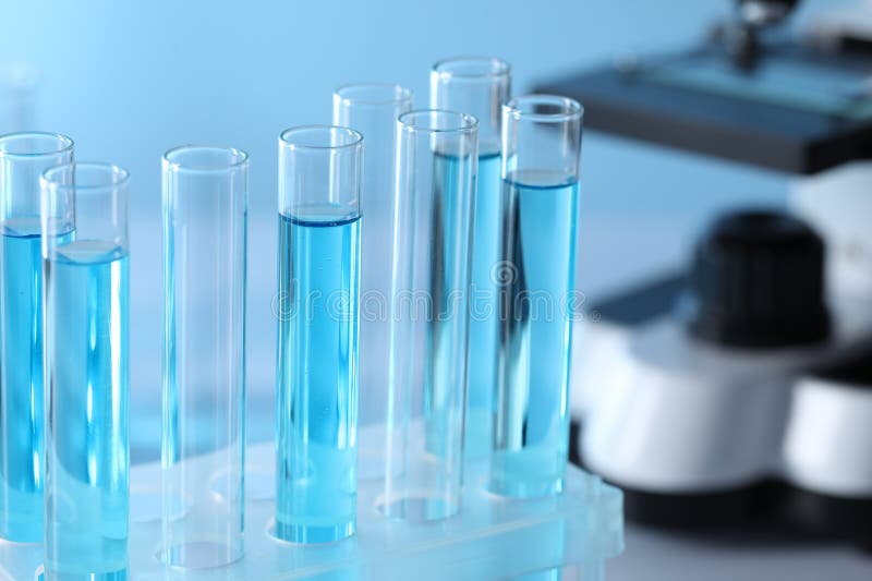 Test Tubes with Light Blue Liquid in Laboratory, Closeup Stock Photo ...