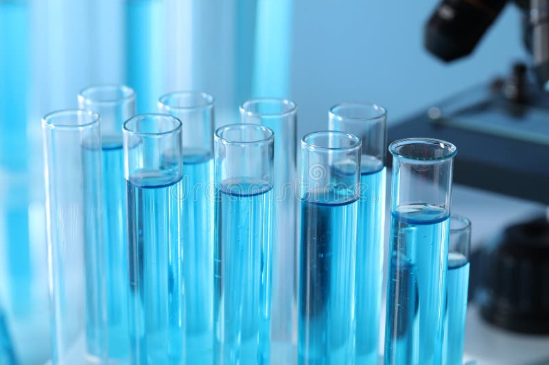 Test Tubes with Light Blue Liquid in Laboratory, Closeup Stock Photo ...