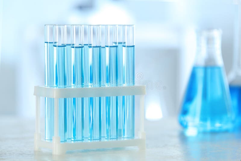 Test Tubes With Light Blue Liquid On Table Stock Photo - Image of ...