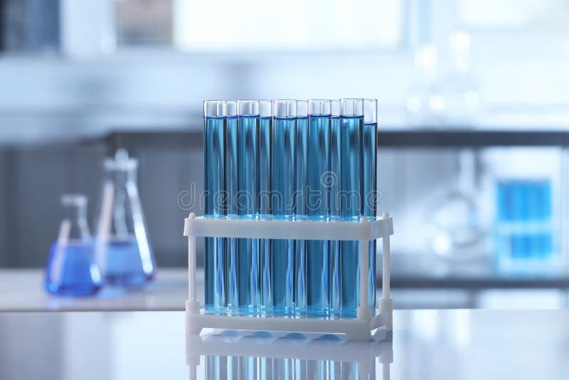 Test Tubes with Light Blue Liquid on Table in Laboratory Stock Photo ...