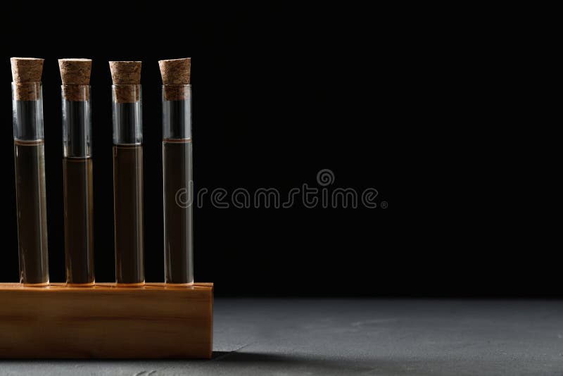 Test Tubes with Liquid in Stand on Grey Table. Space for Text Stock ...
