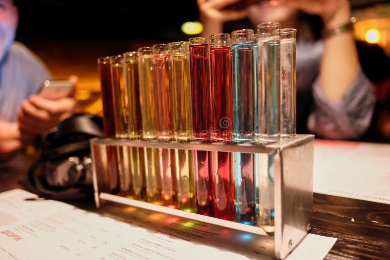 Test Tubes with Multi-colored Liquid. Alcohol in Test Tubes in Dark Bar ...