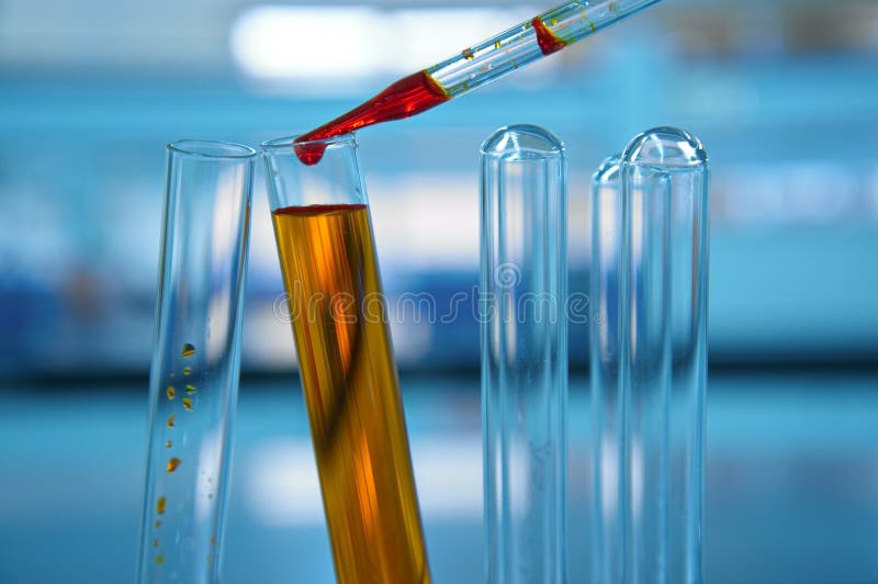 Test Tubes in Science Lab with Orange Solution Drop Stock Image - Image ...