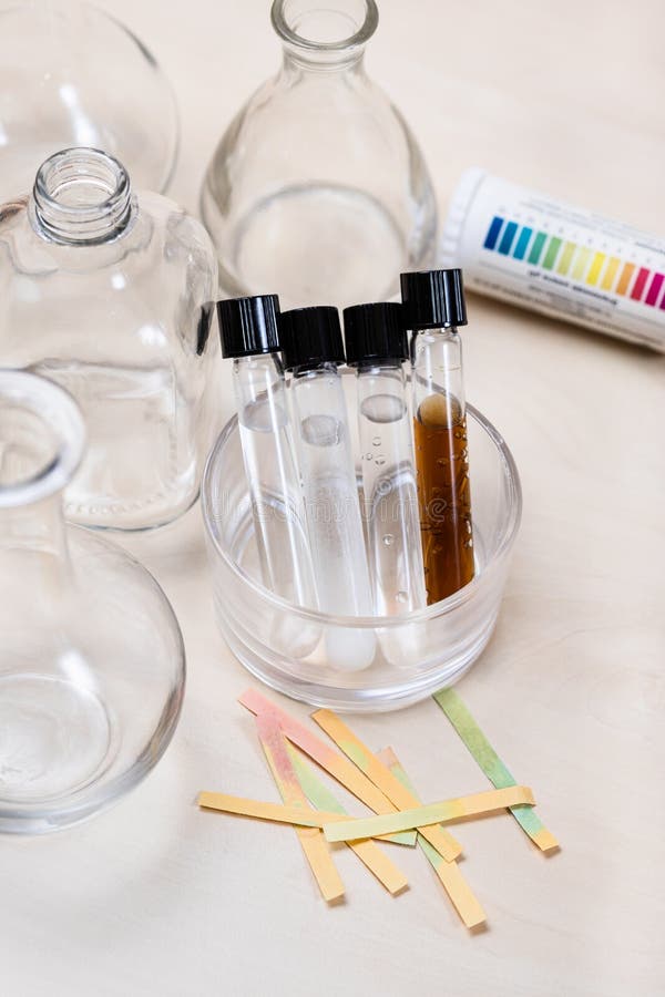 Test Tubes with Various Solutions, Bottles on Desk Stock Image - Image ...